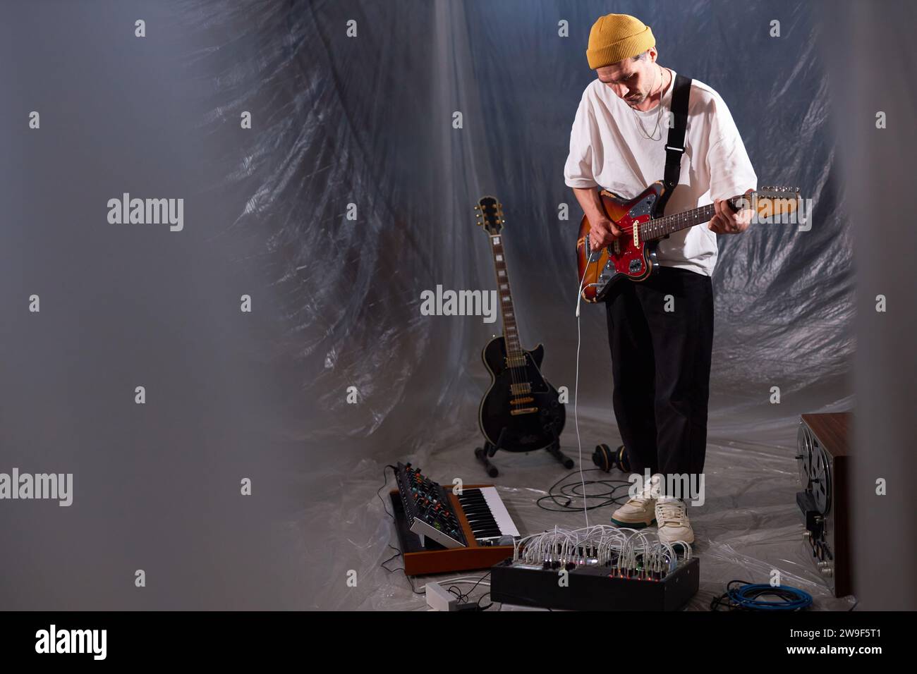 Male Guitarist Recording Audio Samples in Studio Stock Photo - Alamy