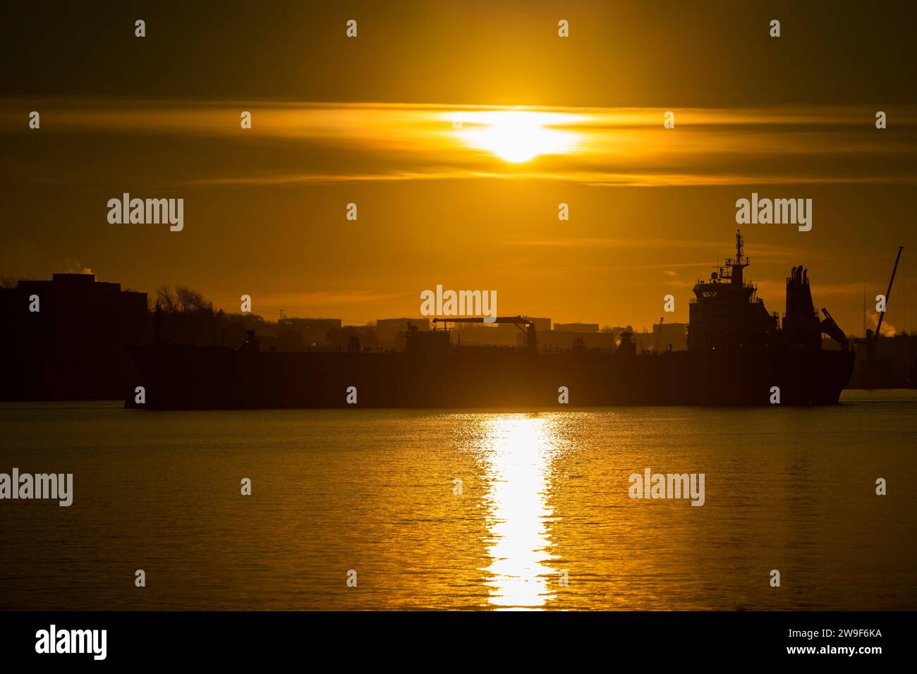 Sun rising behind a cargo ship in Halifax Harbour Stock Photo - Alamy
