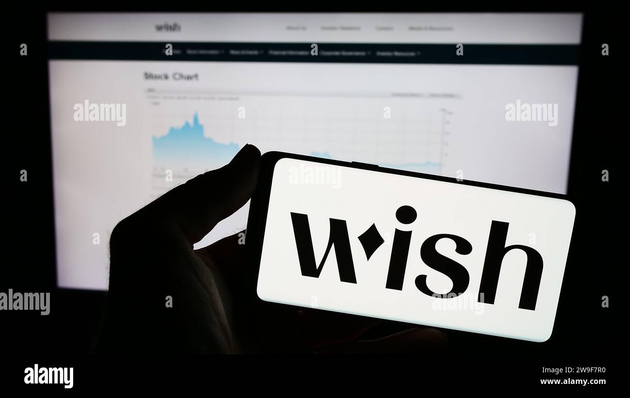 Person holding mobile phone with logo of American e-commerce platform ...