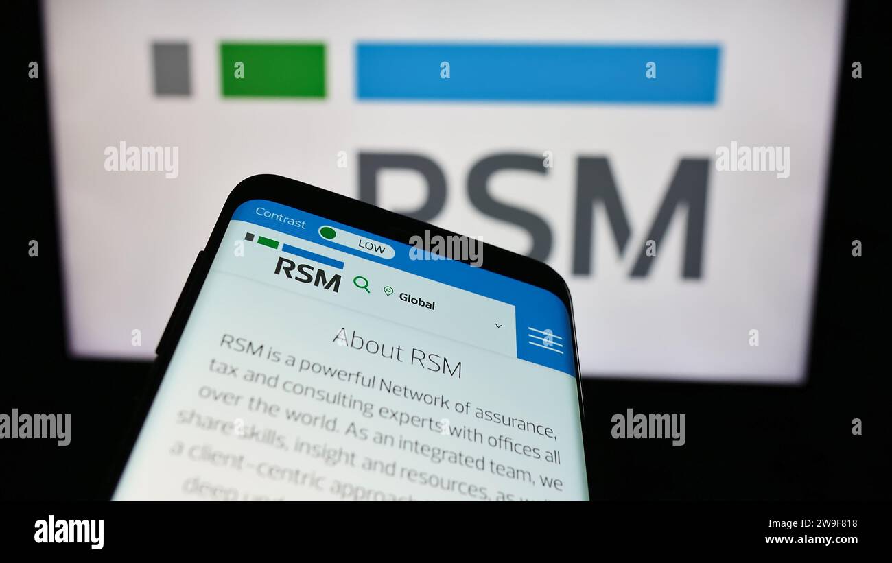 Mobile phone with website of global accounting company RSM International Ltd. in front of ...