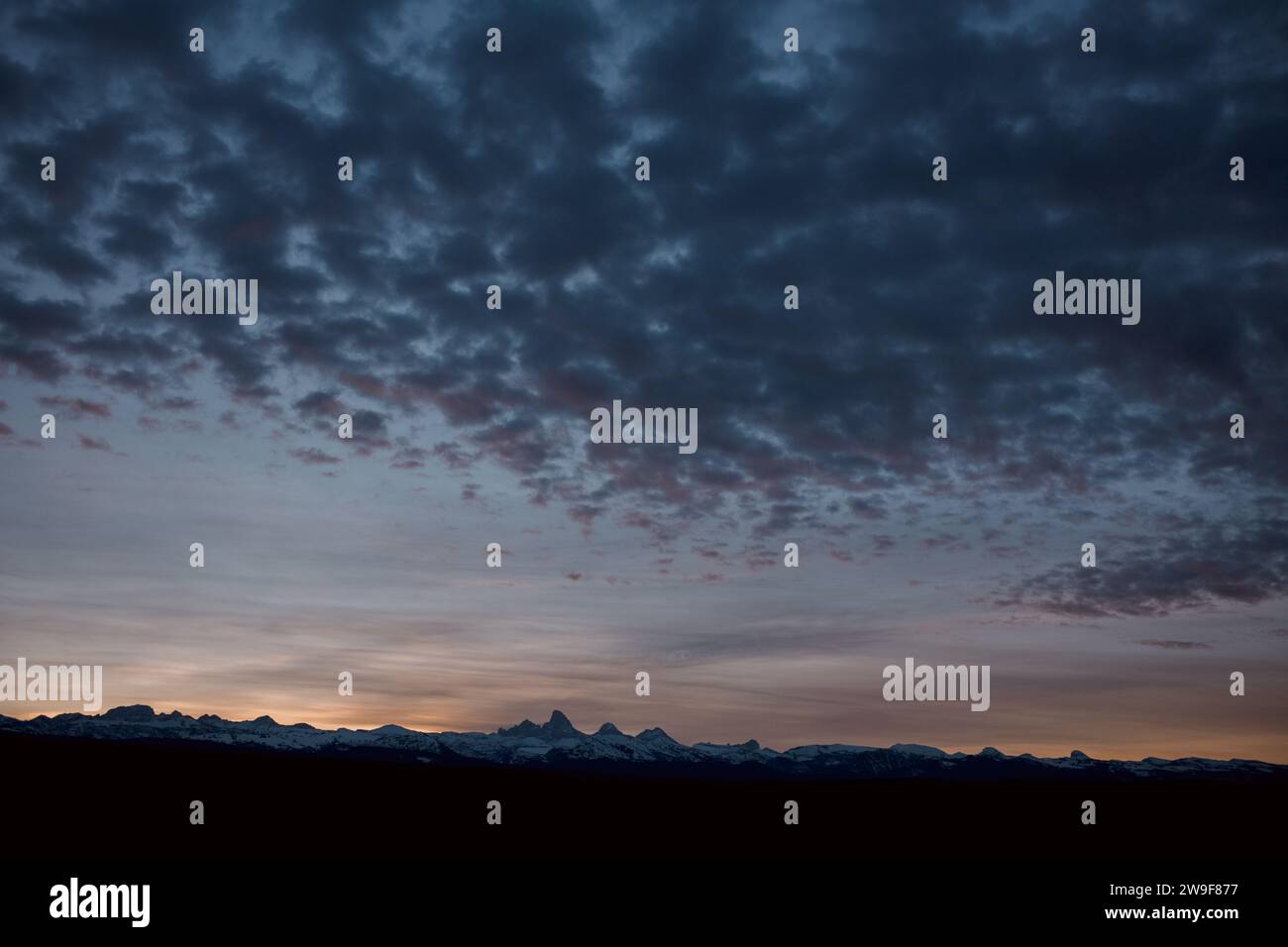Sunrise clouds blue hour Tetons mountains from a distance, copy space ...