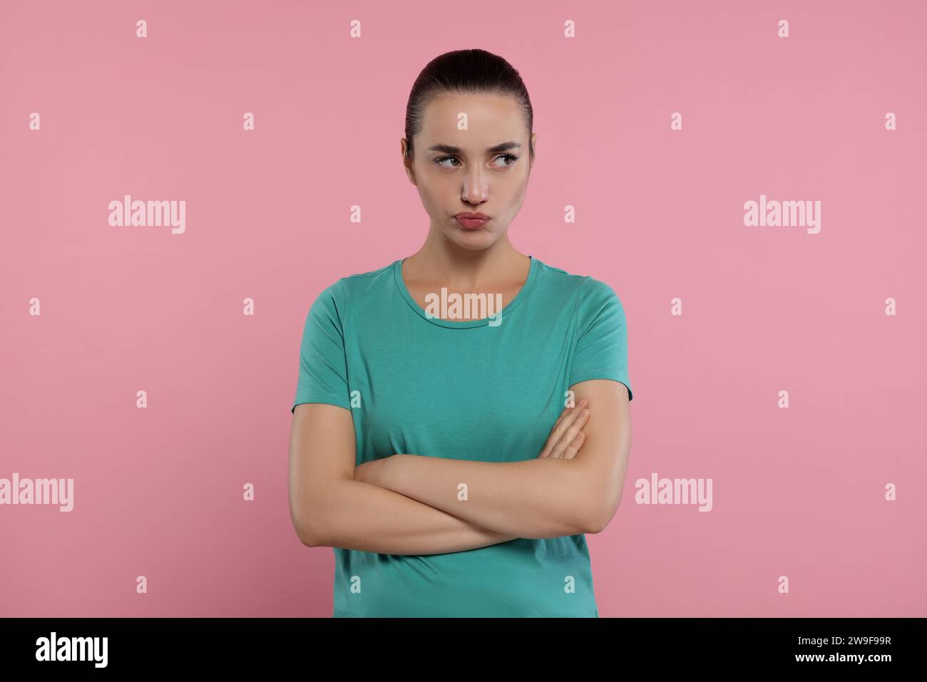 Portrait of resentful woman with crossed arms on pink background Stock ...