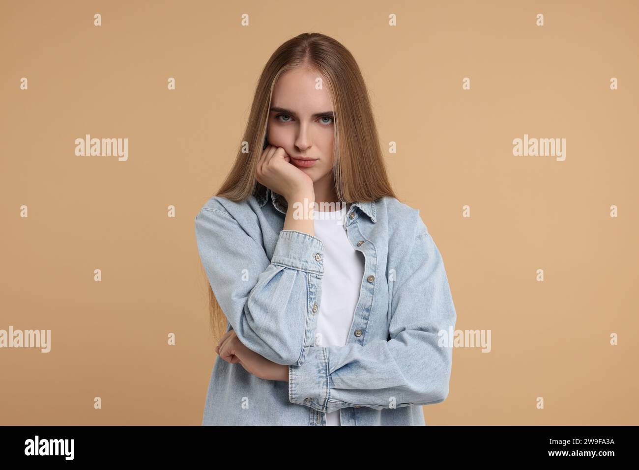 Portrait of resentful woman on beige background Stock Photo - Alamy