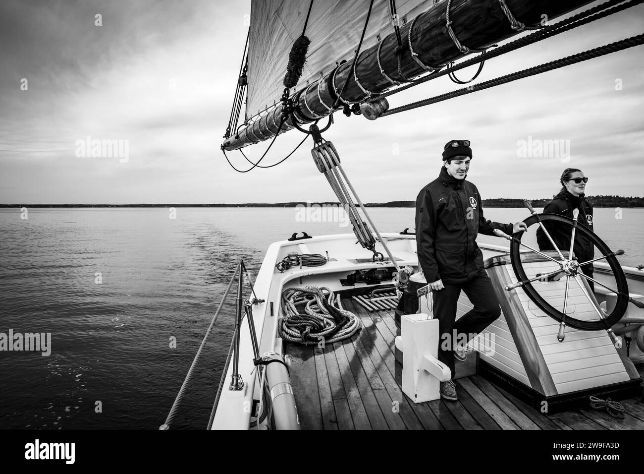 Crew members operate the helm onboard the replica Grand Banks fishing ...