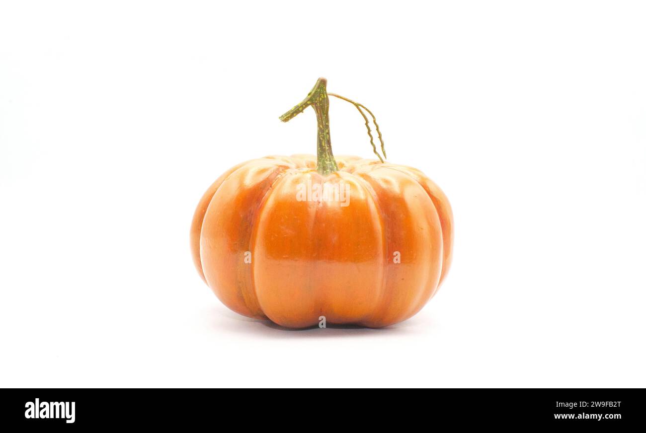 Small orange whole miniature pumpkin Jack O lantern with green stem ...