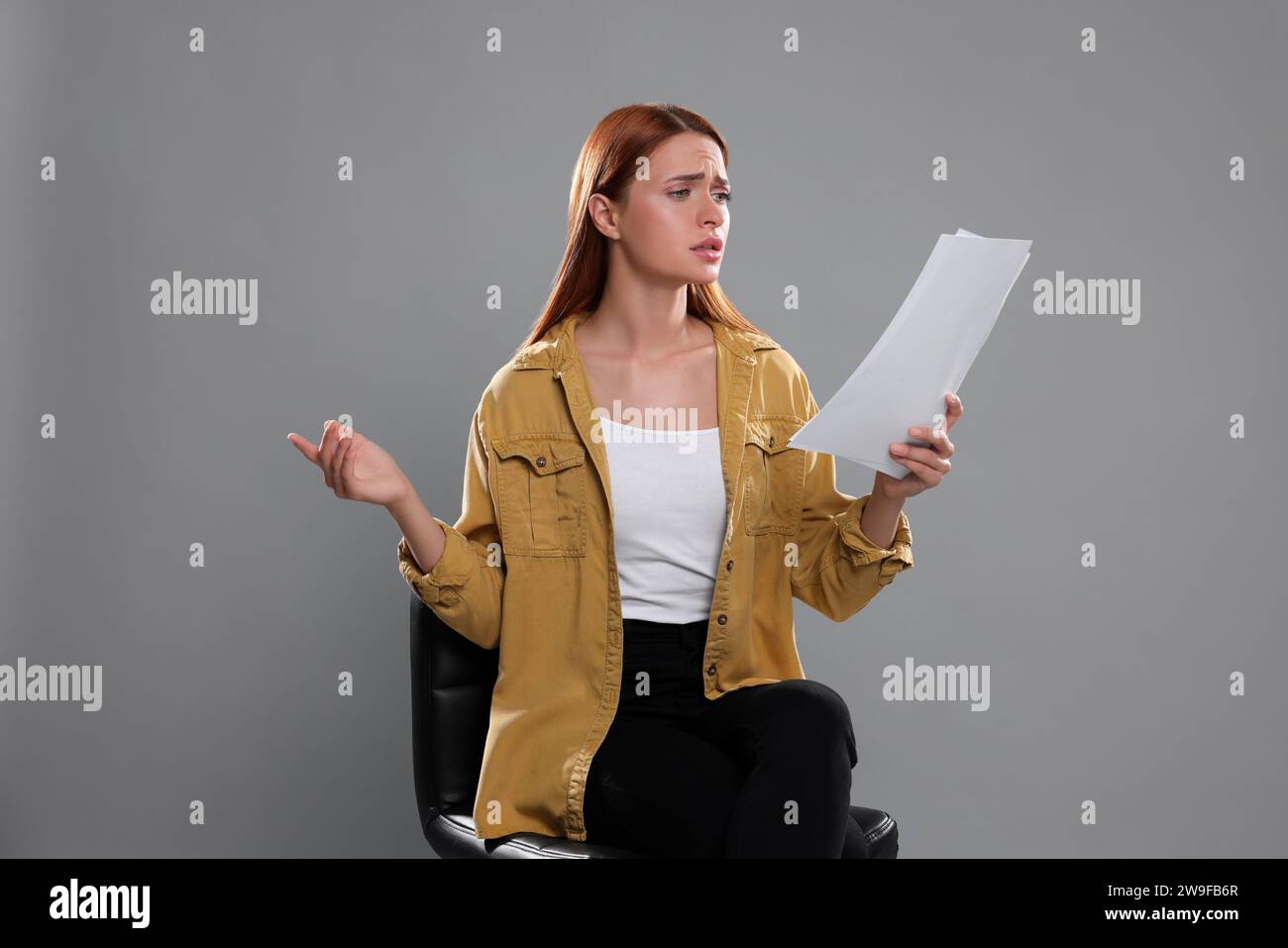 Casting call. Emotional woman with script performing on grey background ...