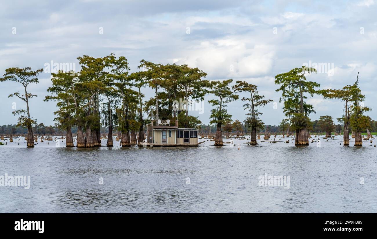 House boat with balcony moored in calm waters of the bayou of ...