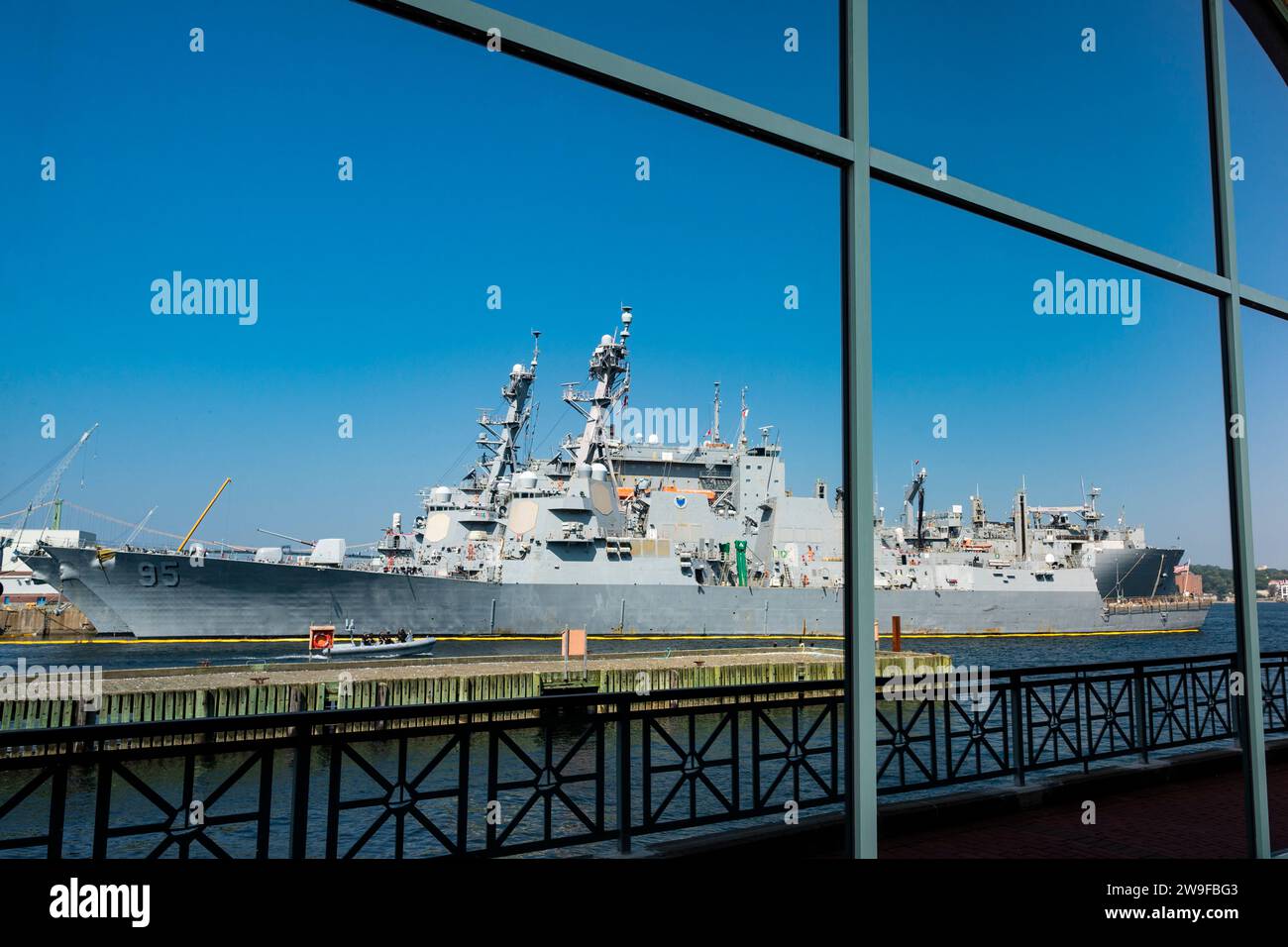 US Navy destroyer USS James E Williams reflected on a glass window ...