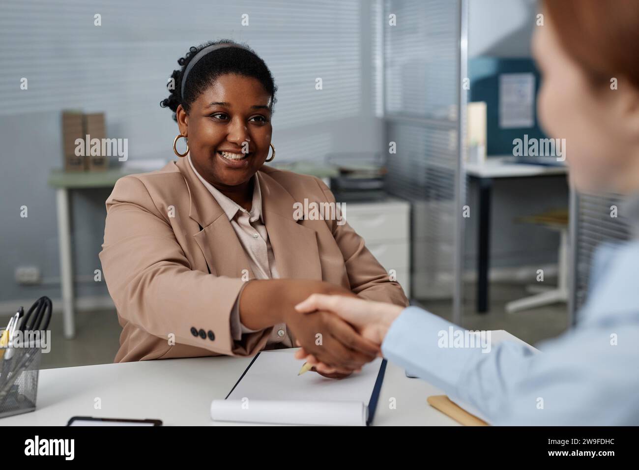 Cheerful HR Agent Welcoming New Company Employees Stock Photo - Alamy