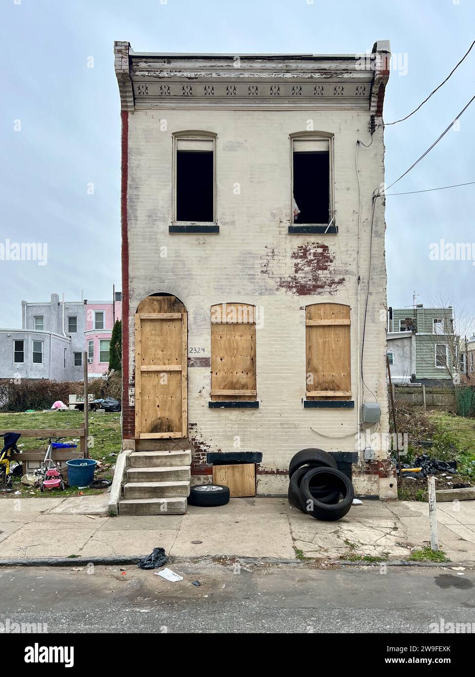 Tires sit piled up in front of a vacant rowhome in the Sharswood ...