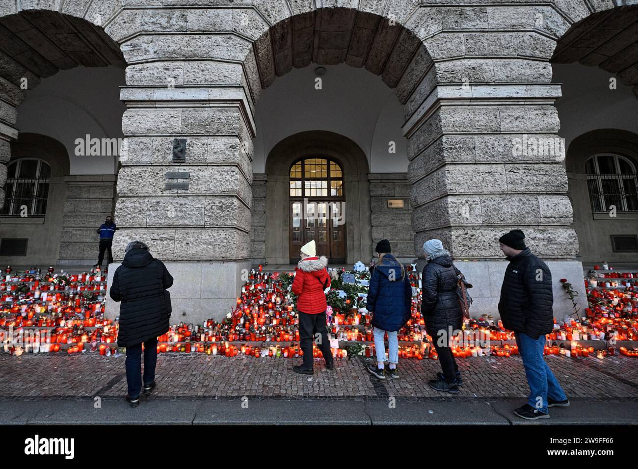 Prague, Czech Republic. 27th Dec, 2023. People light candles in front ...