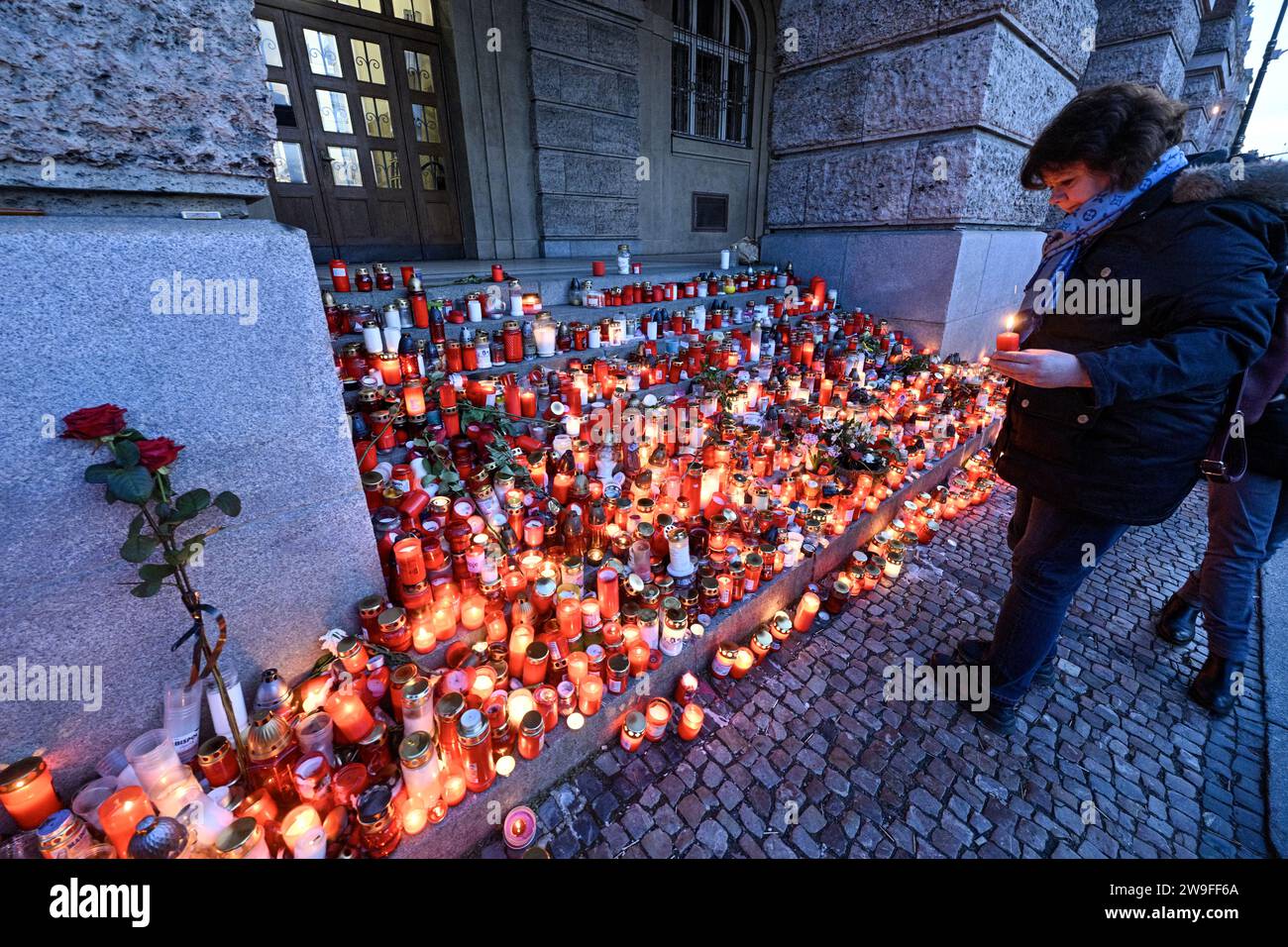 Prague, Czech Republic. 27th Dec, 2023. People light candles in front ...