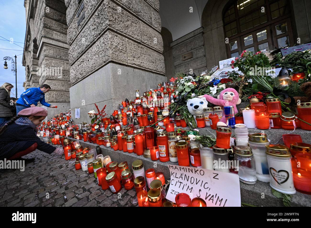 Prague, Czech Republic. 27th Dec, 2023. People light candles in front ...