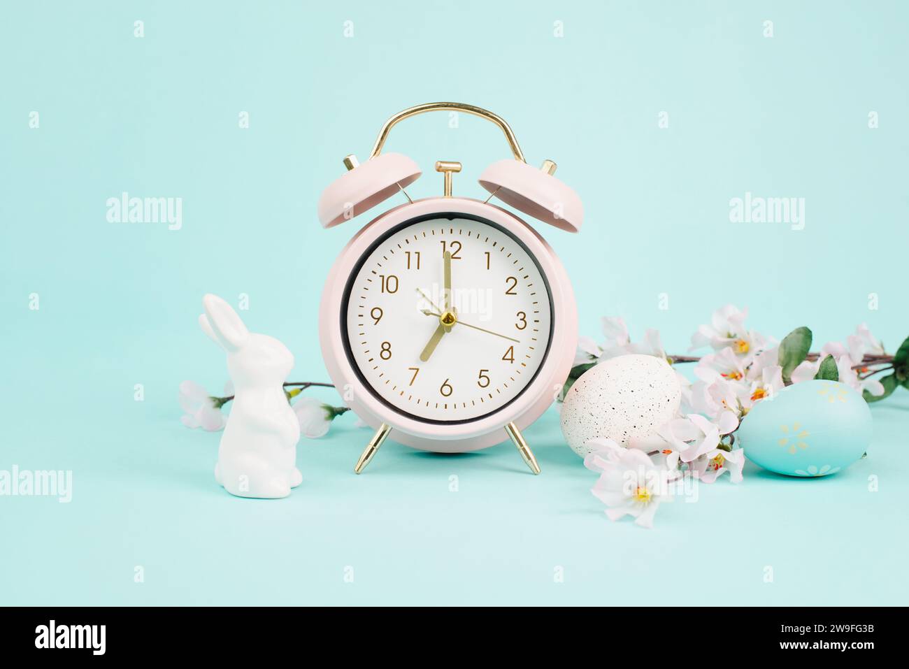 Cute easter bunny or rabbit with an alarm clock, eggs and cherry ...