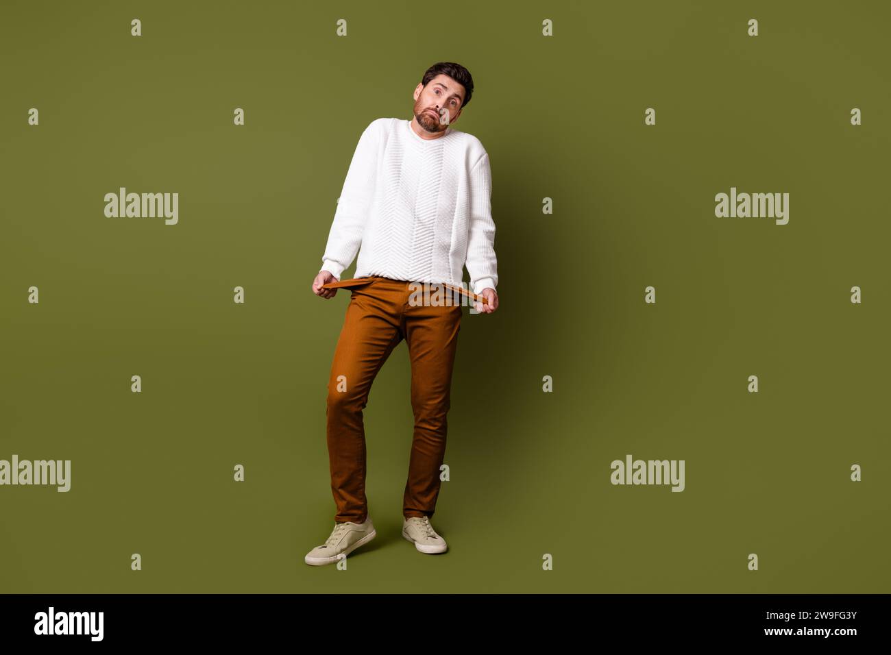 Photo of poor jobless man wear trendy clothes standing empty pockets ...