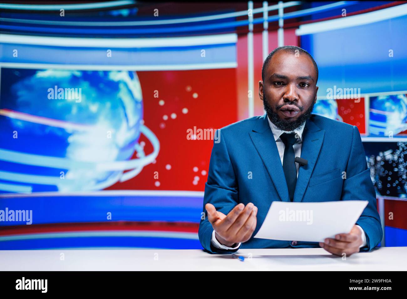 News reporter delivering breaking news on media segment in newsroom ...