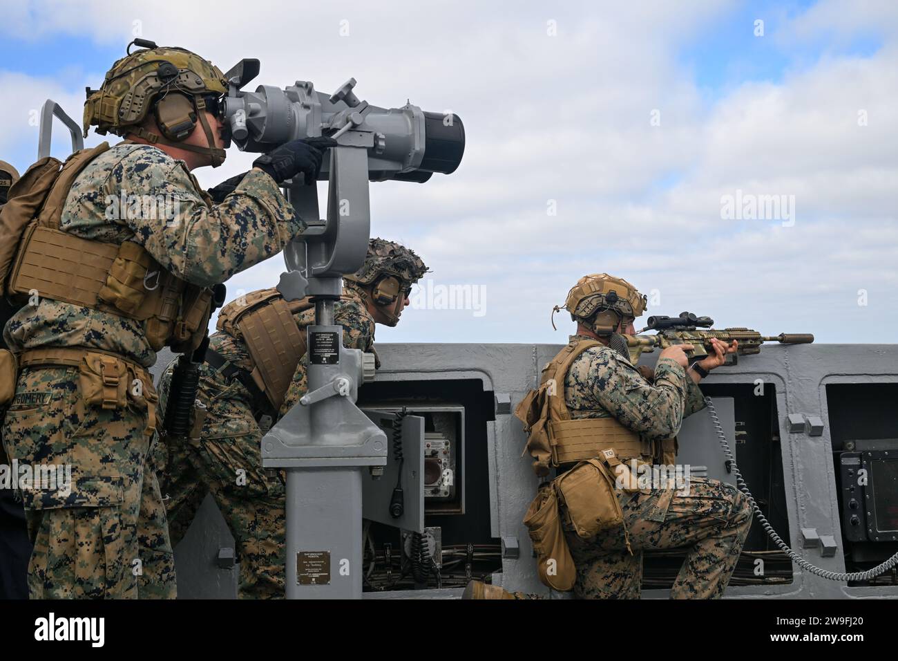 Marines assigned to the 15th Marine Expeditionary Unit monitor surface ...