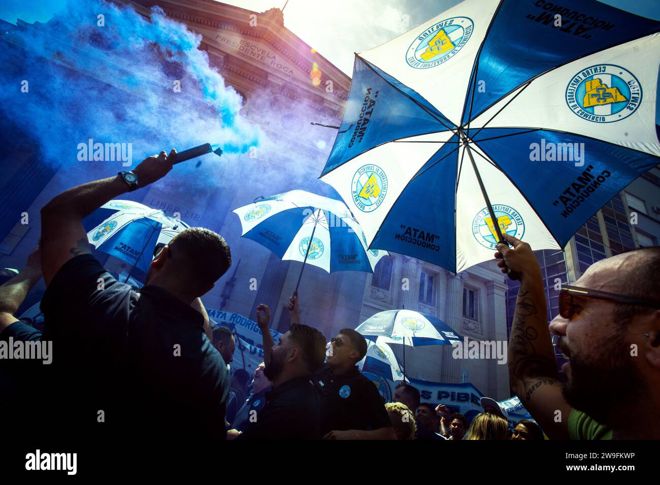 Buenos Aires, Argentina. 27th Dec, 2023. Protesters hold smoke flares ...