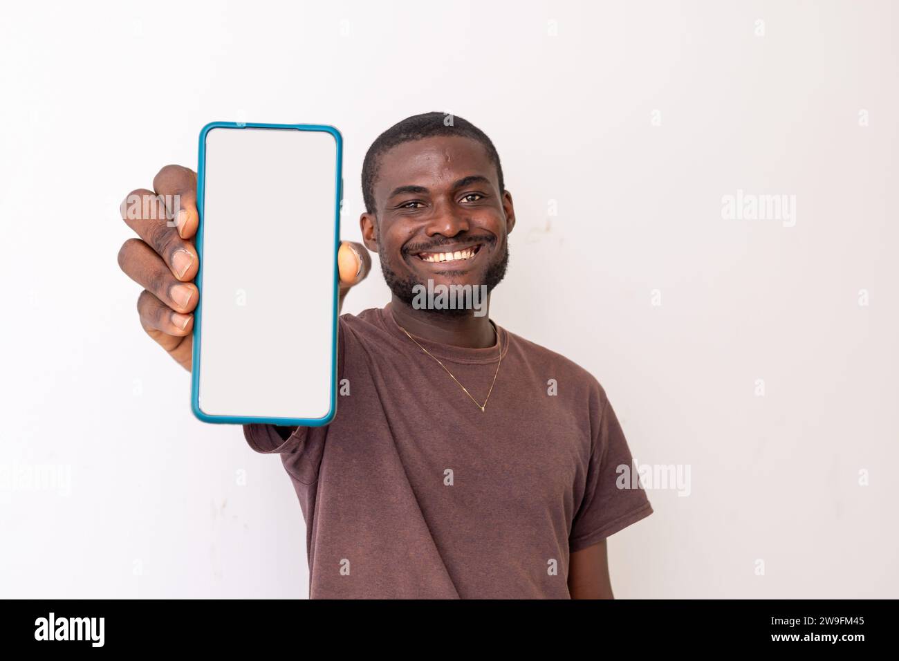 excited black African american guy holding big smartphone with white ...