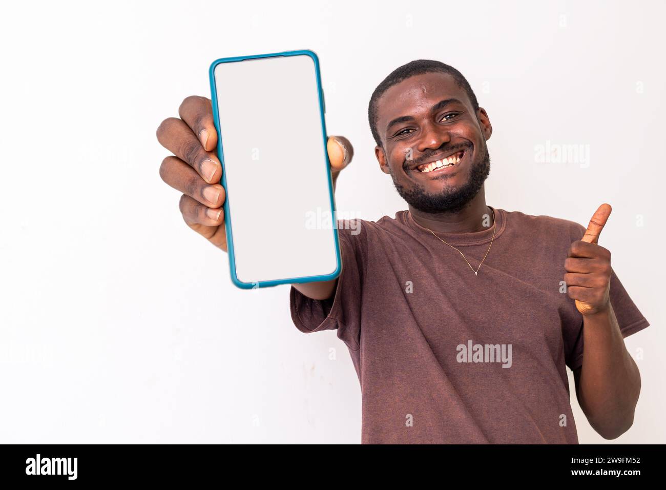 excited black African american guy holding big smartphone with white ...