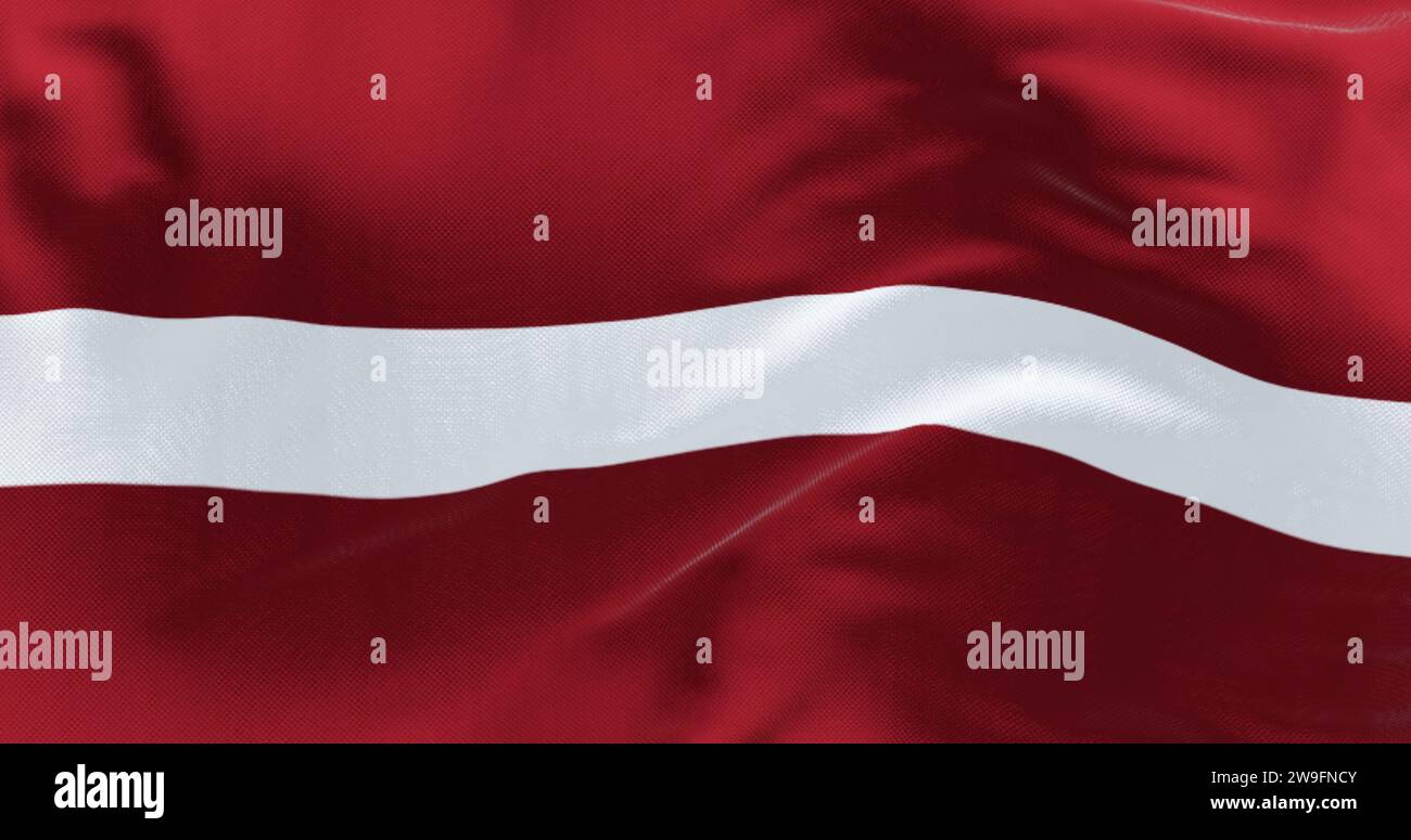 Close-up view of the Latvia national flag waving in the wind. Carmine ...