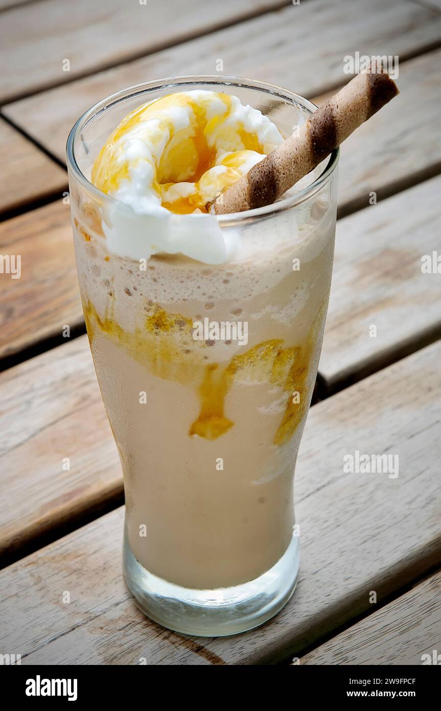 Caramel Choco Float Drink in a glass container placed on the table ...