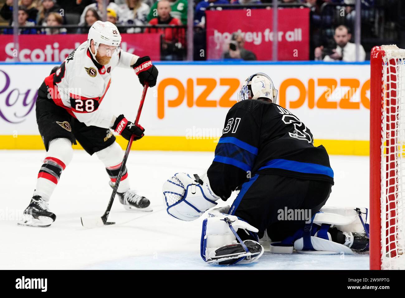 Toronto Maple Leafs goaltender Martin Jones (31) poke-checks Ottawa ...