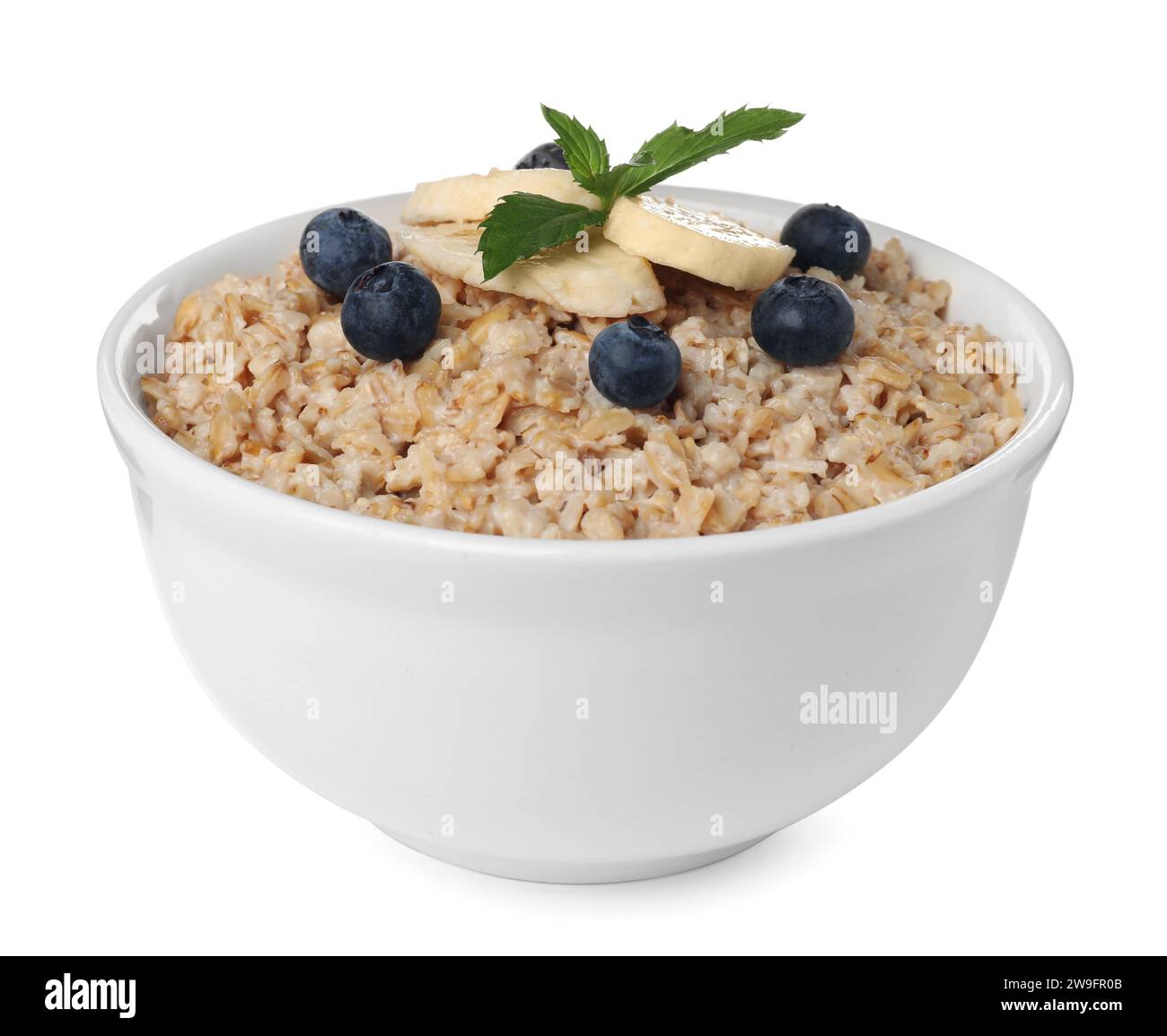 Tasty boiled oatmeal with blueberries and banana in bowl isolated on ...