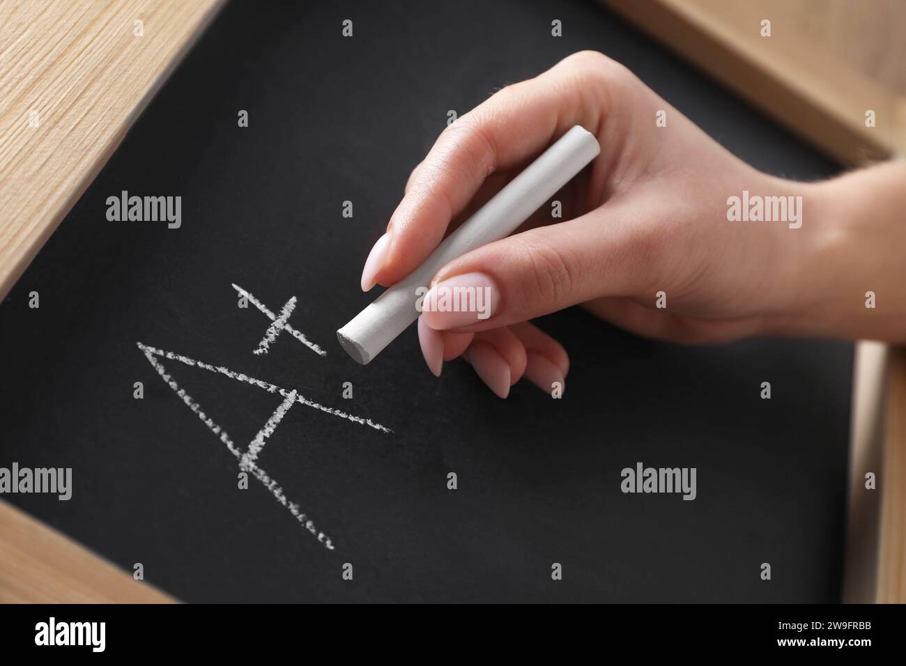Female teacher grading writing hi-res stock photography and images - Alamy