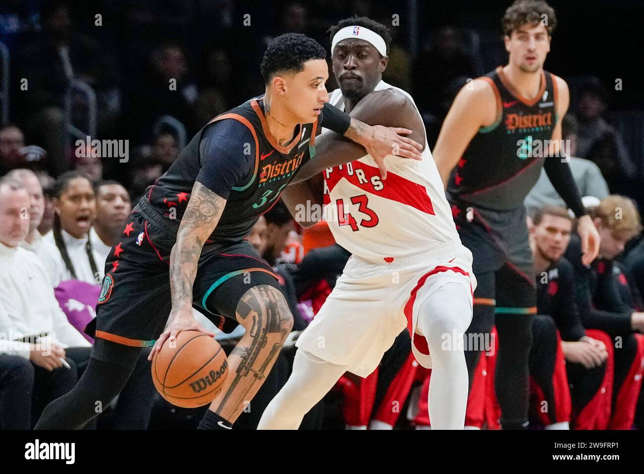 Washington Wizards forward Kyle Kuzma (33) drives past Toronto Raptors forward Pascal Siakam (43 ...