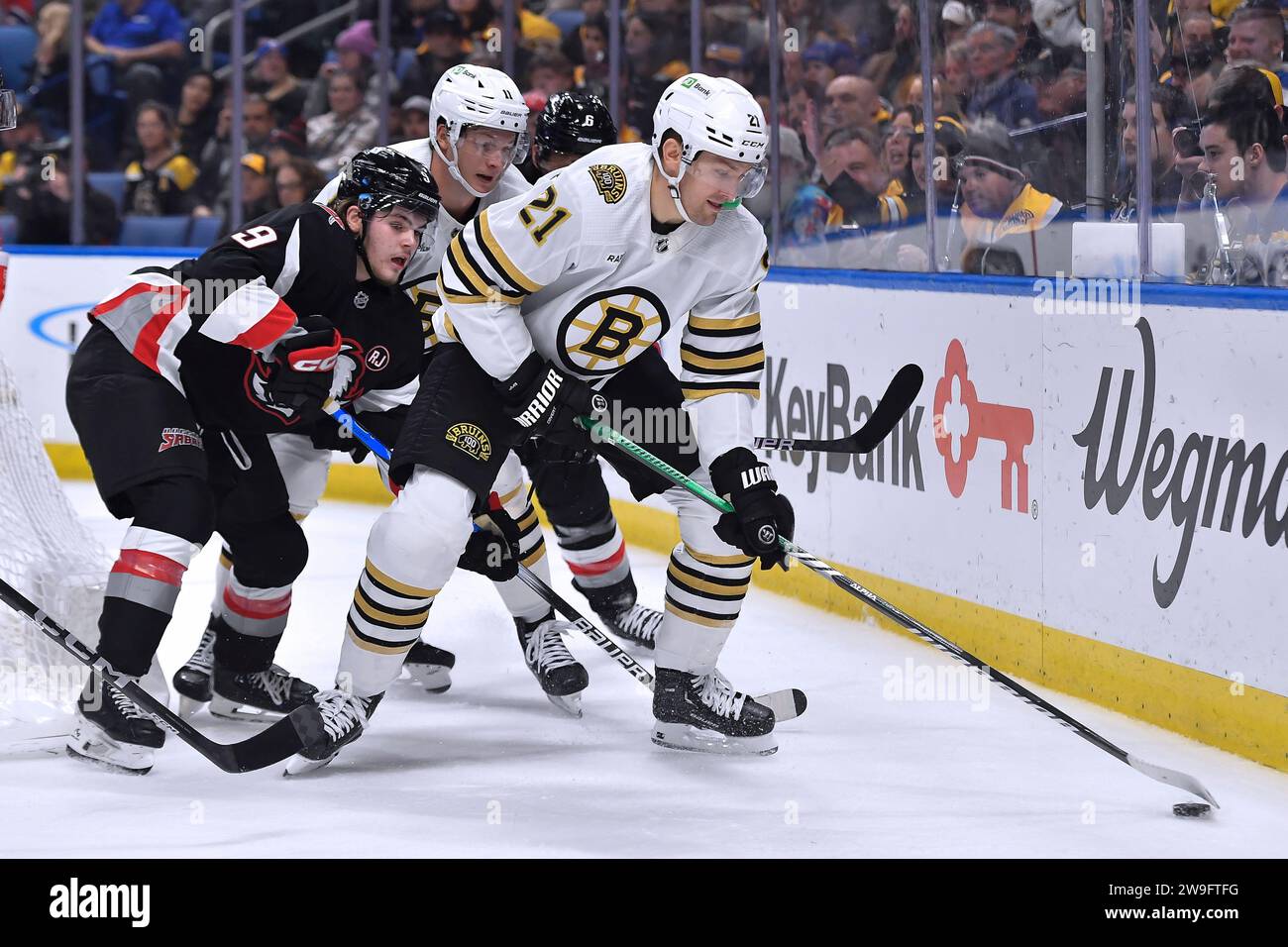 Boston Bruins left wing James van Riemsdyk, right, shields the puck ...