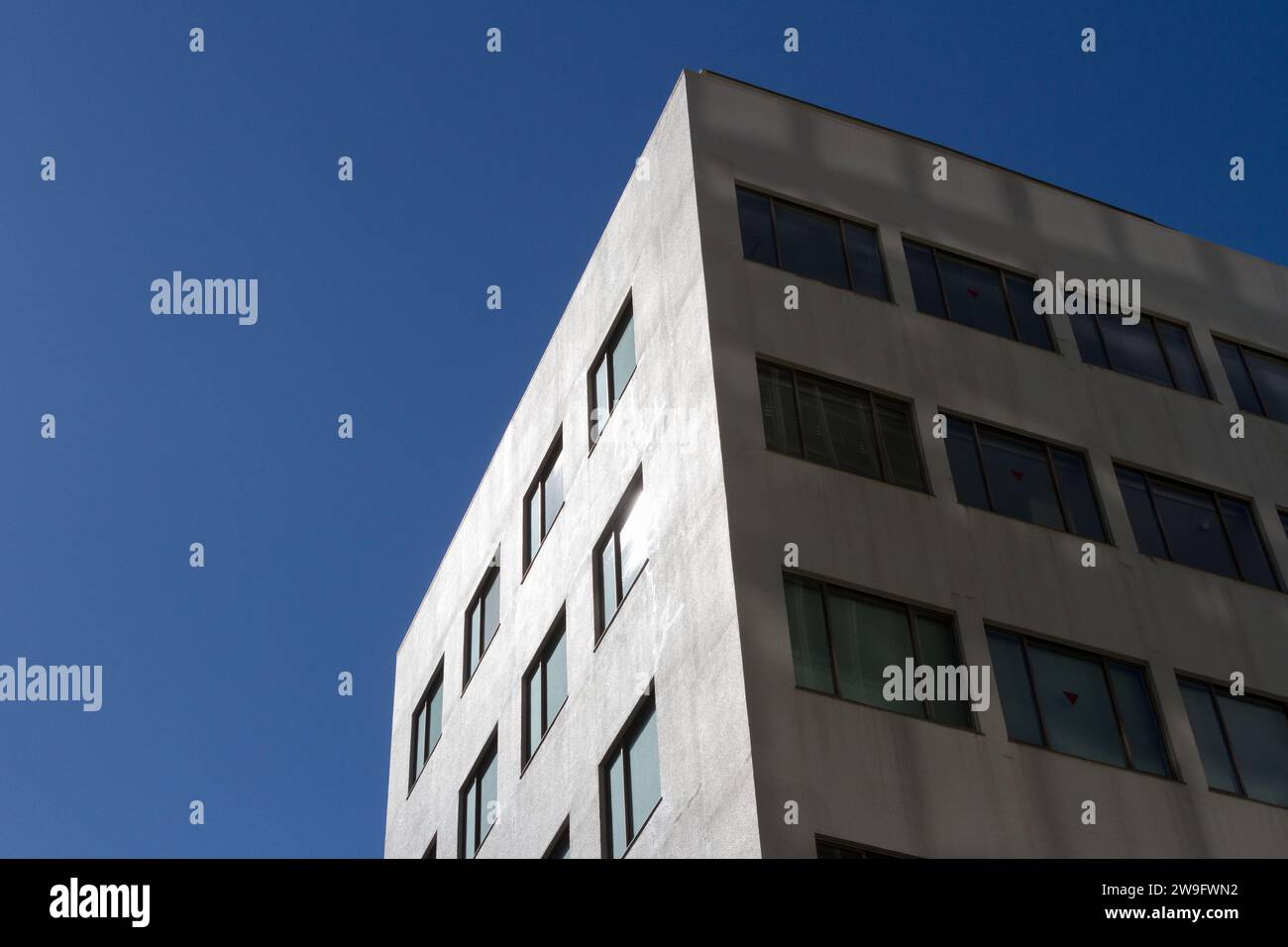 Abstract image of the corner of a nondescript office building in Tokyo ...