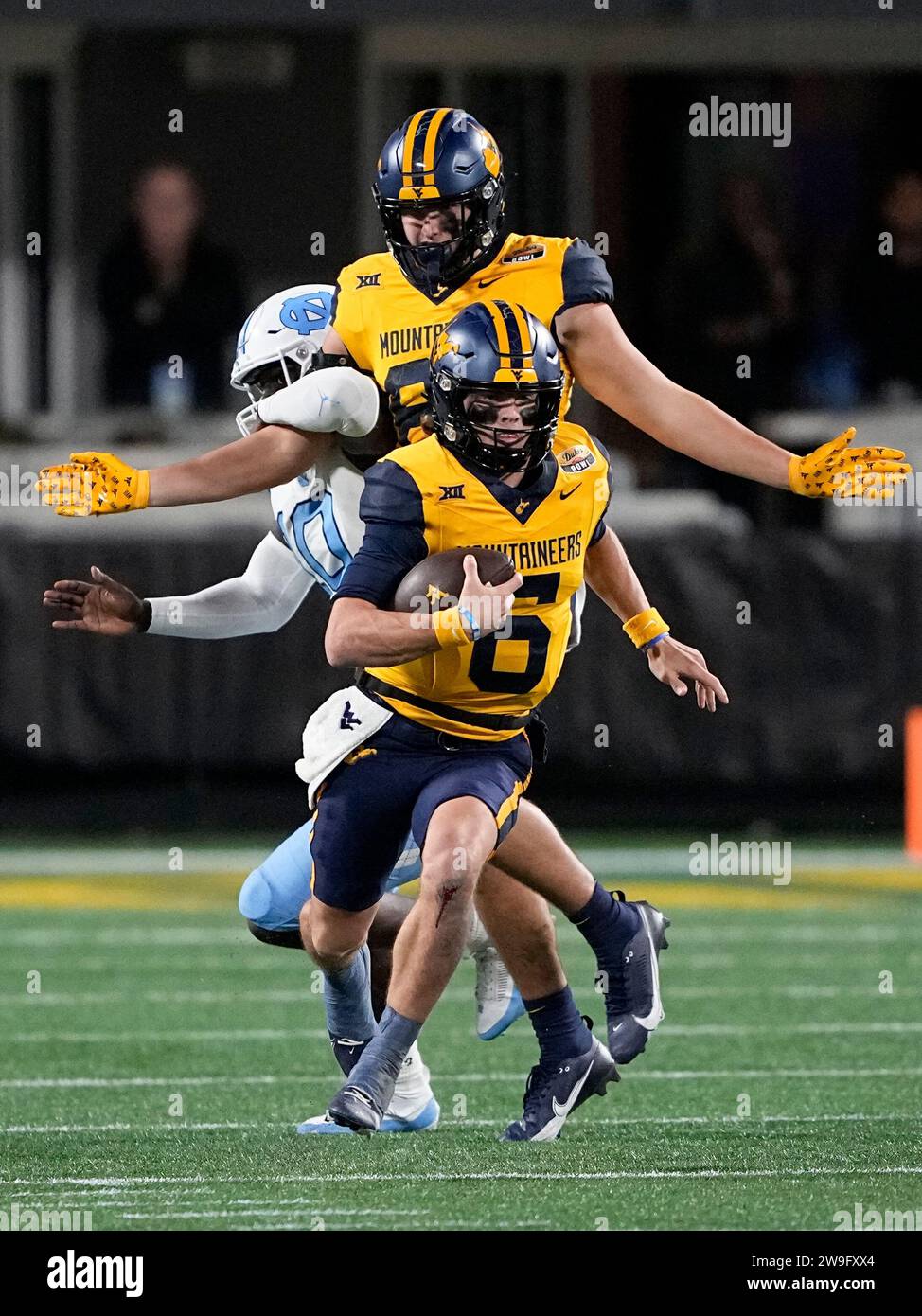 West Virginia quarterback Garrett Greene runs against North Carolina ...