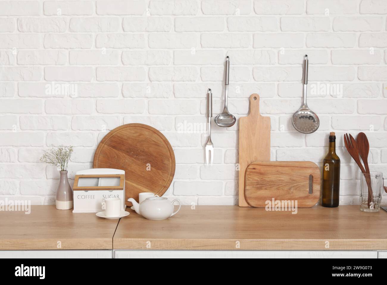Wooden counters with cutting boards and utensils in modern kitchen ...