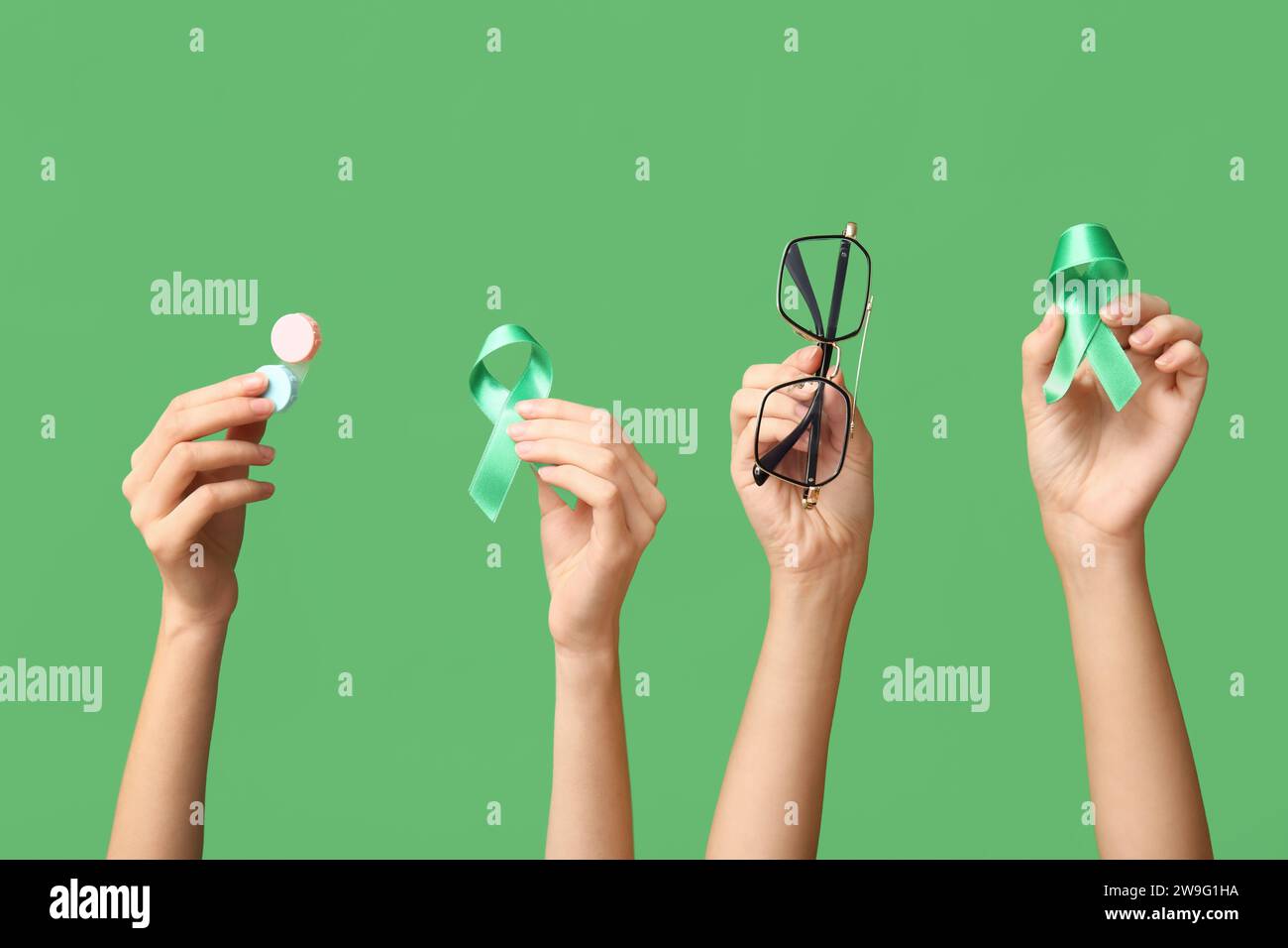 Female hands with ribbons, eyeglasses and container for contact lenses ...