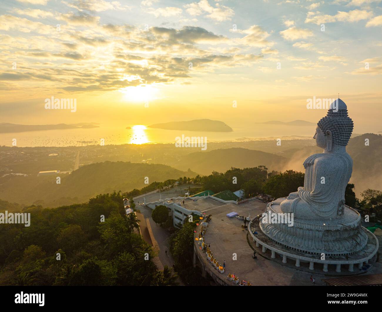 Aerial view The golden sun shines through the clouds above the ocean at ...