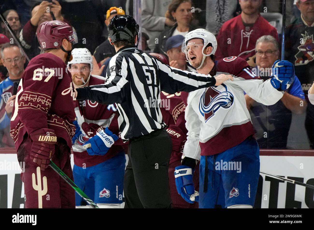 Linesman Justin Johnson (57) separates Arizona Coyotes left wing Lawson ...