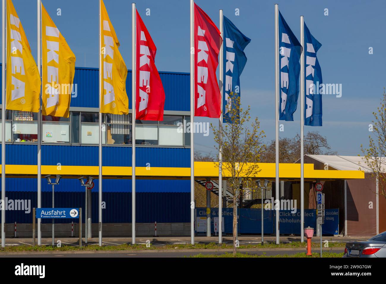 Koblenz, Germany - April 22, 2021: flags in blue, red and yellow with the IKEA logo in front of ...