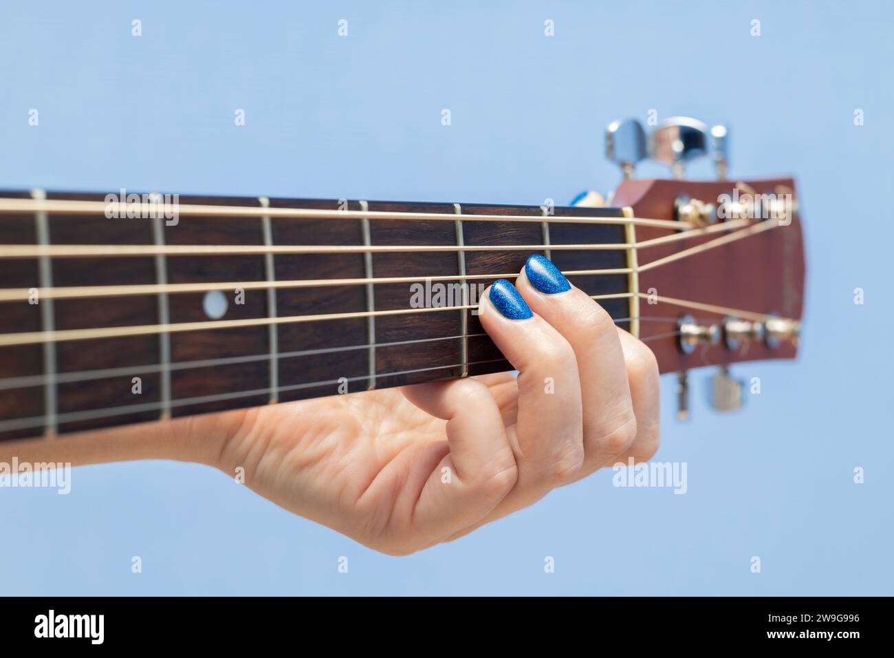 female fingers pinch the strings on a guitar Stock Photo - Alamy
