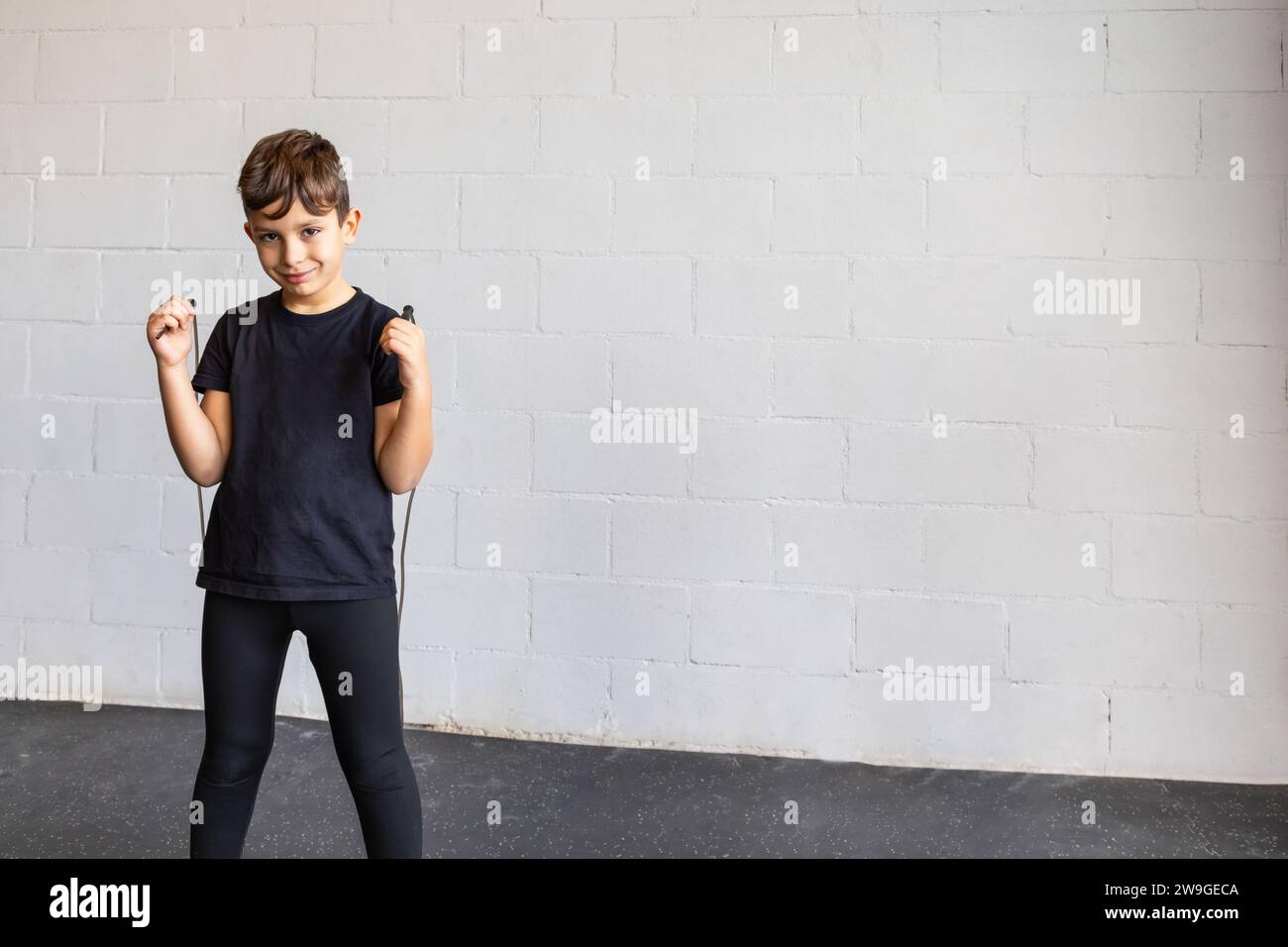 Horizontal photo elementary boy, dressed in leggings and black t-shirt ...