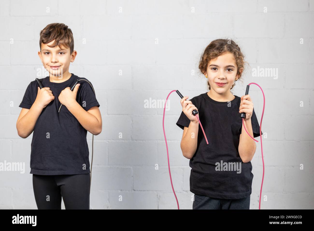 Horizontal photo elementary boy and girl, dressed in leggings and black ...