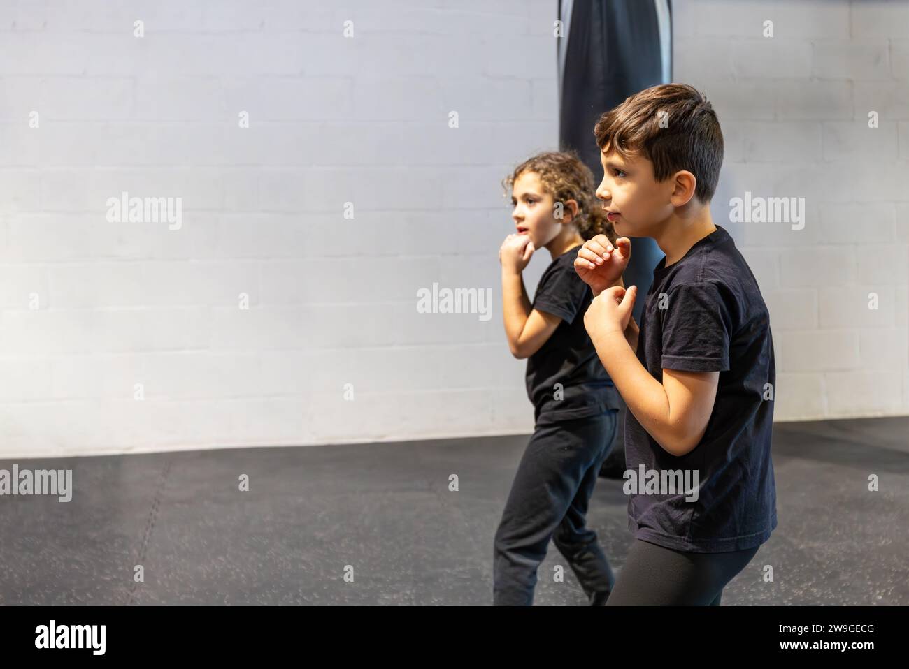 Horizontal photo elementary boy and girl, dressed in tights and black t ...