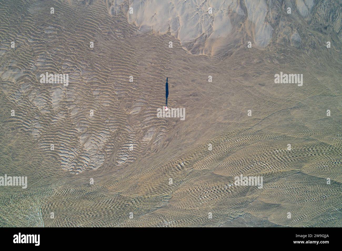 zenithal aerial view with drone of a person on the beach in summer at ...