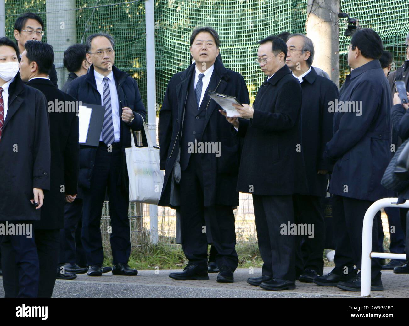 Japanese Chief Cabinet Secretary Yoshimasa Hayashi (C) walks around the ...