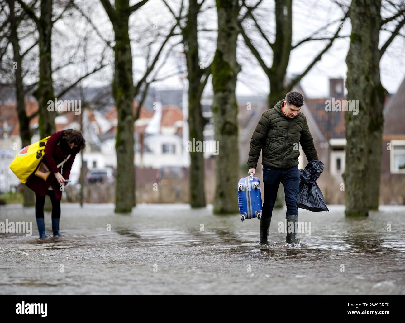 DEVENTER - People walk through a flooded street in Deventer. The water ...