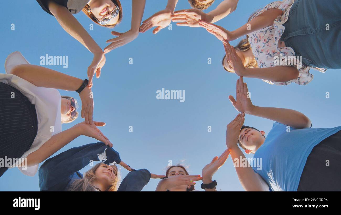 School friends make a big circle with their hands Stock Photo - Alamy