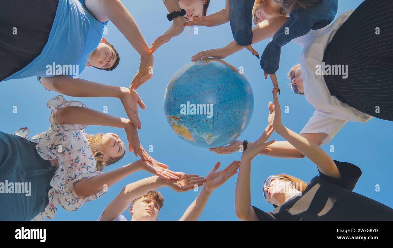 Group of people around a world map hi-res stock photography and images ...