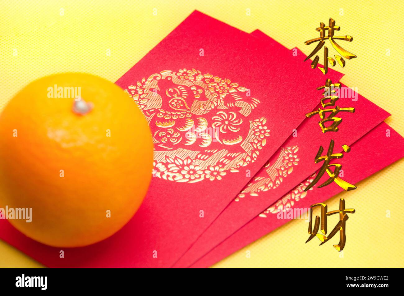 Chinese New Year red packets and orange on yellow cover background ...