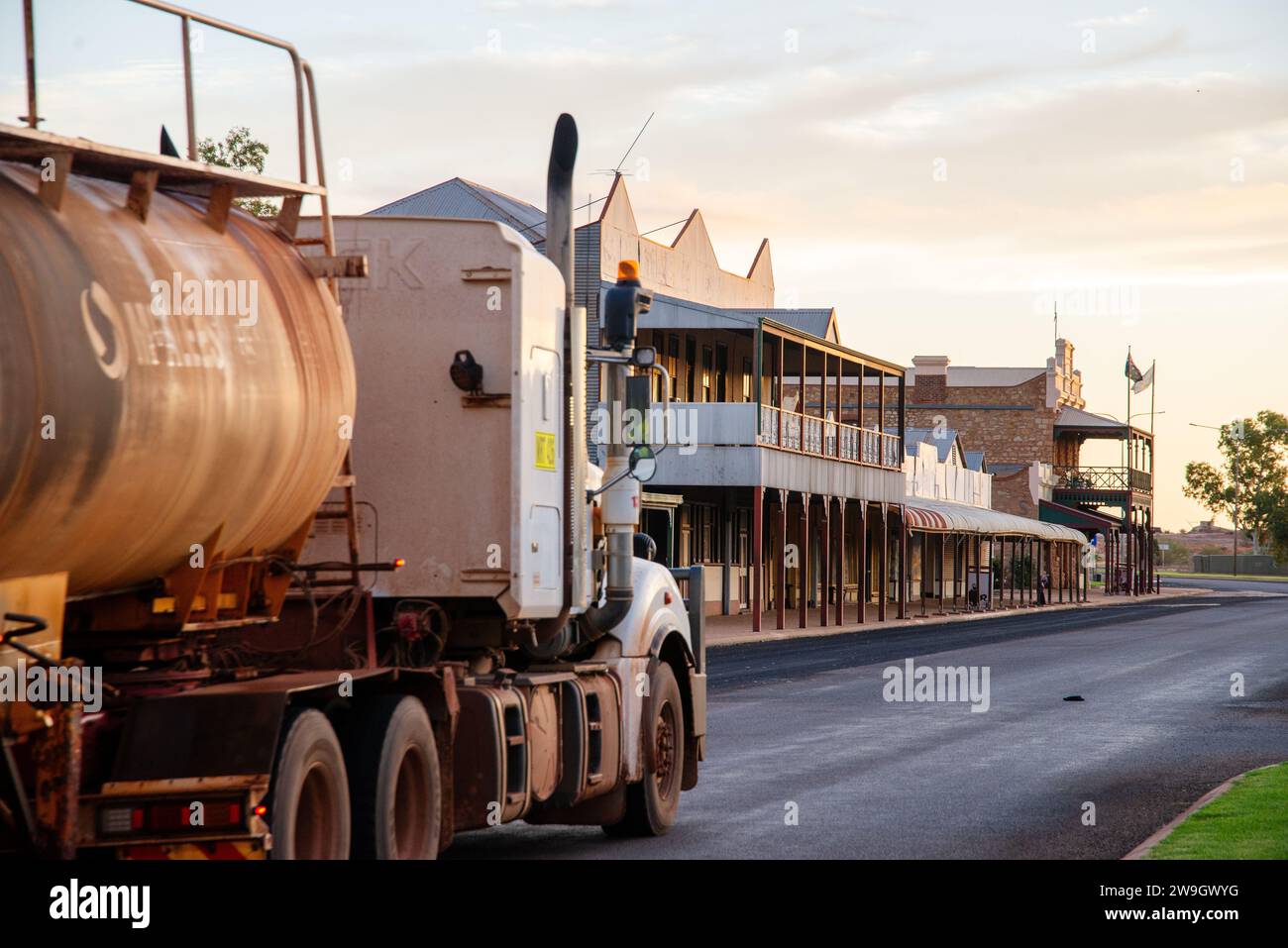A road train transporting mining equipment drives through Cue, Western ...