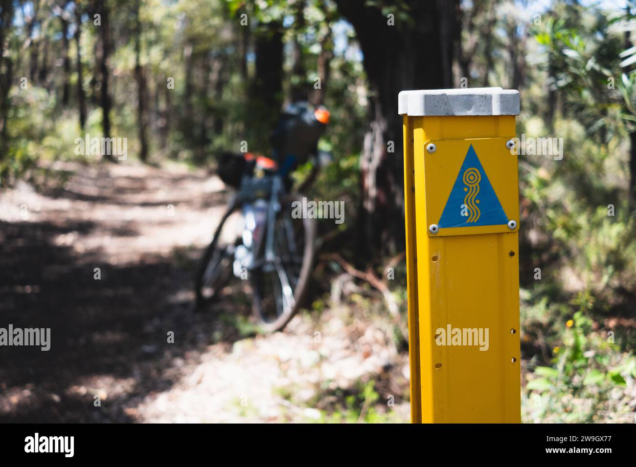 A bicycle leaning against a tree near Dandalup on the Munda Biddi Trail ...